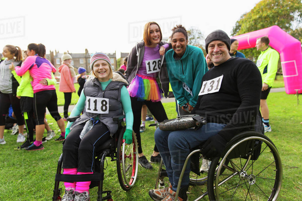 Portrait smiling friends in wheelchairs at charity race in park - Stock ...