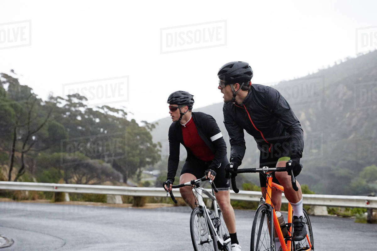 Male cyclists cycling on road - Stock Photo - Dissolve