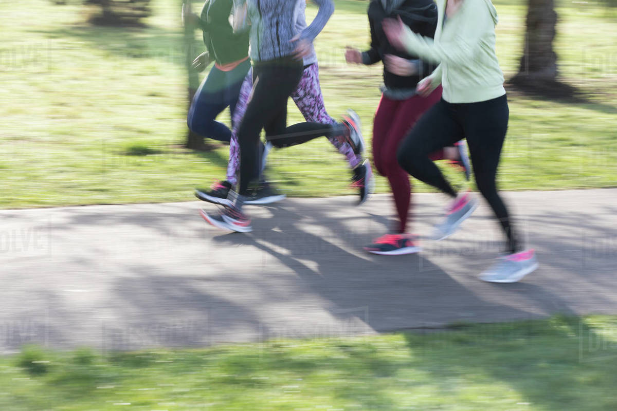 Runners on the move, running in park - Stock Photo - Dissolve