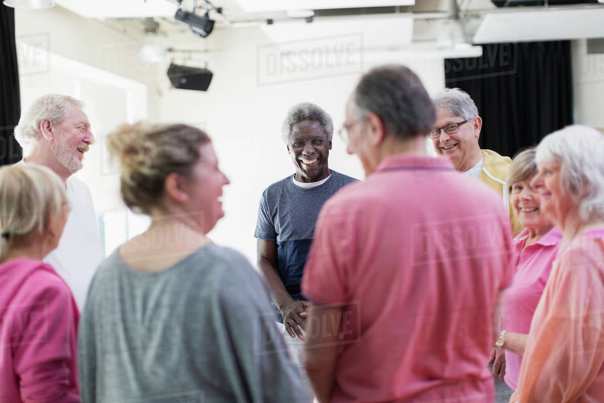 Active seniors talking in circle - Royalty-free Stock Photo | Dissolve