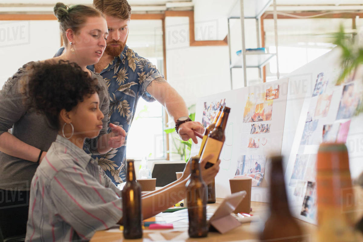 Creative designers people designing bottle label in office - Royalty ...