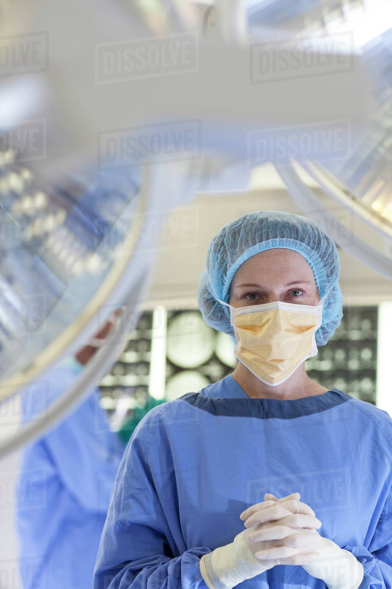 Surgeon standing in operating room - Stock Photo - Dissolve