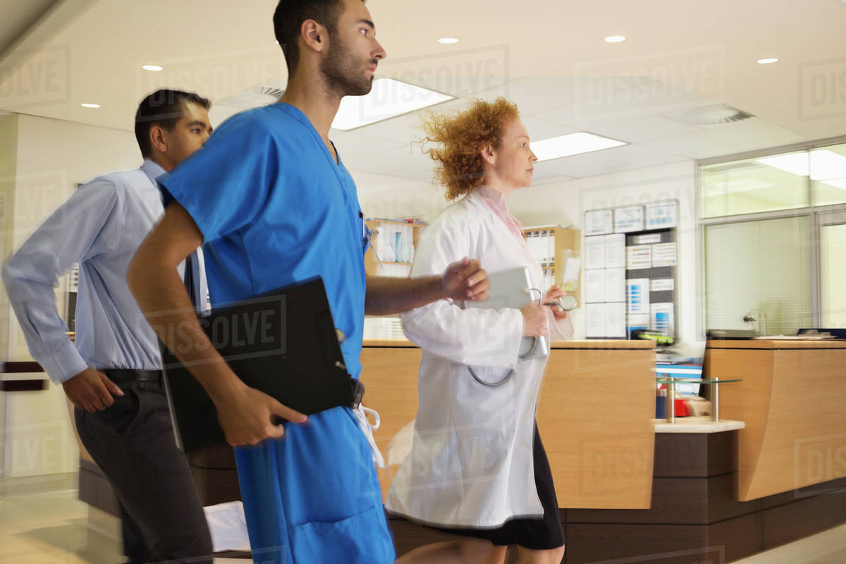 Hospital staff rushing down hallway - Royalty-free Stock Photo | Dissolve