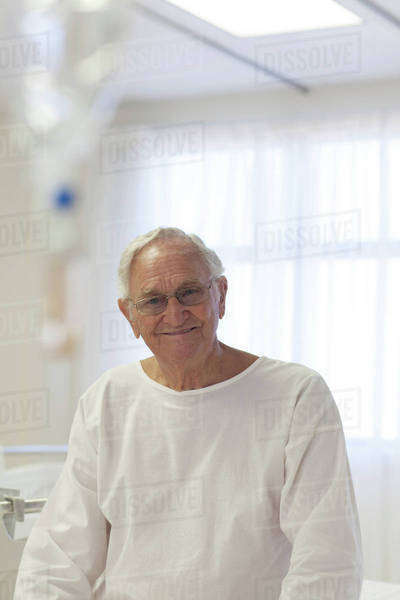 Older patient smiling in hospital room - Stock Photo - Dissolve