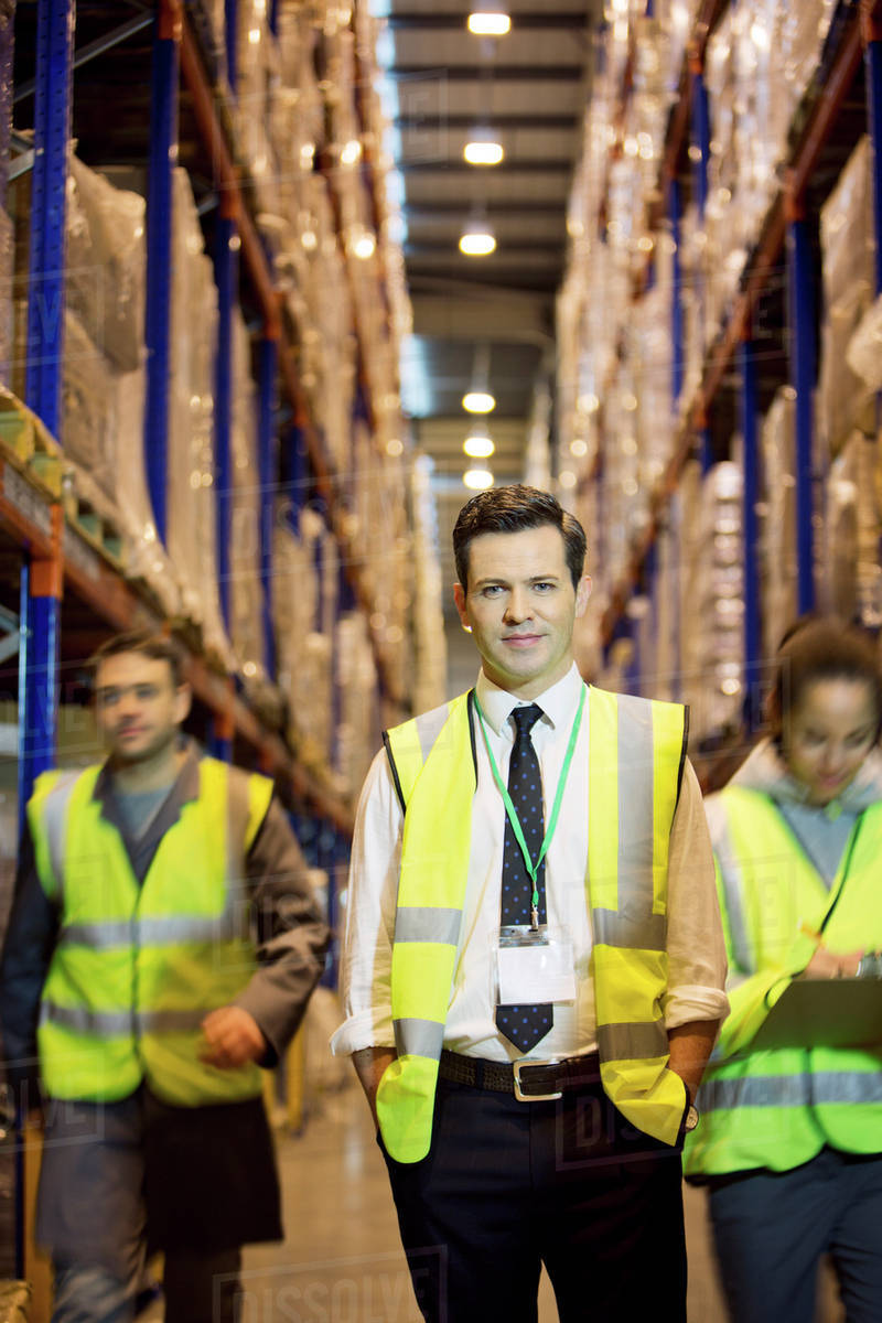 Worker standing in warehouse - Stock Photo - Dissolve