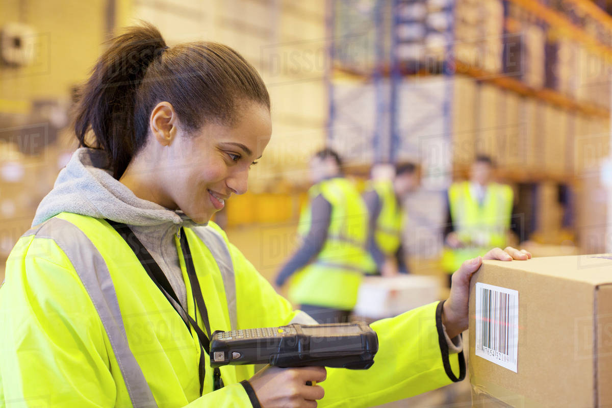 Worker scanning box in warehouse - Royalty-free Stock Photo | Dissolve