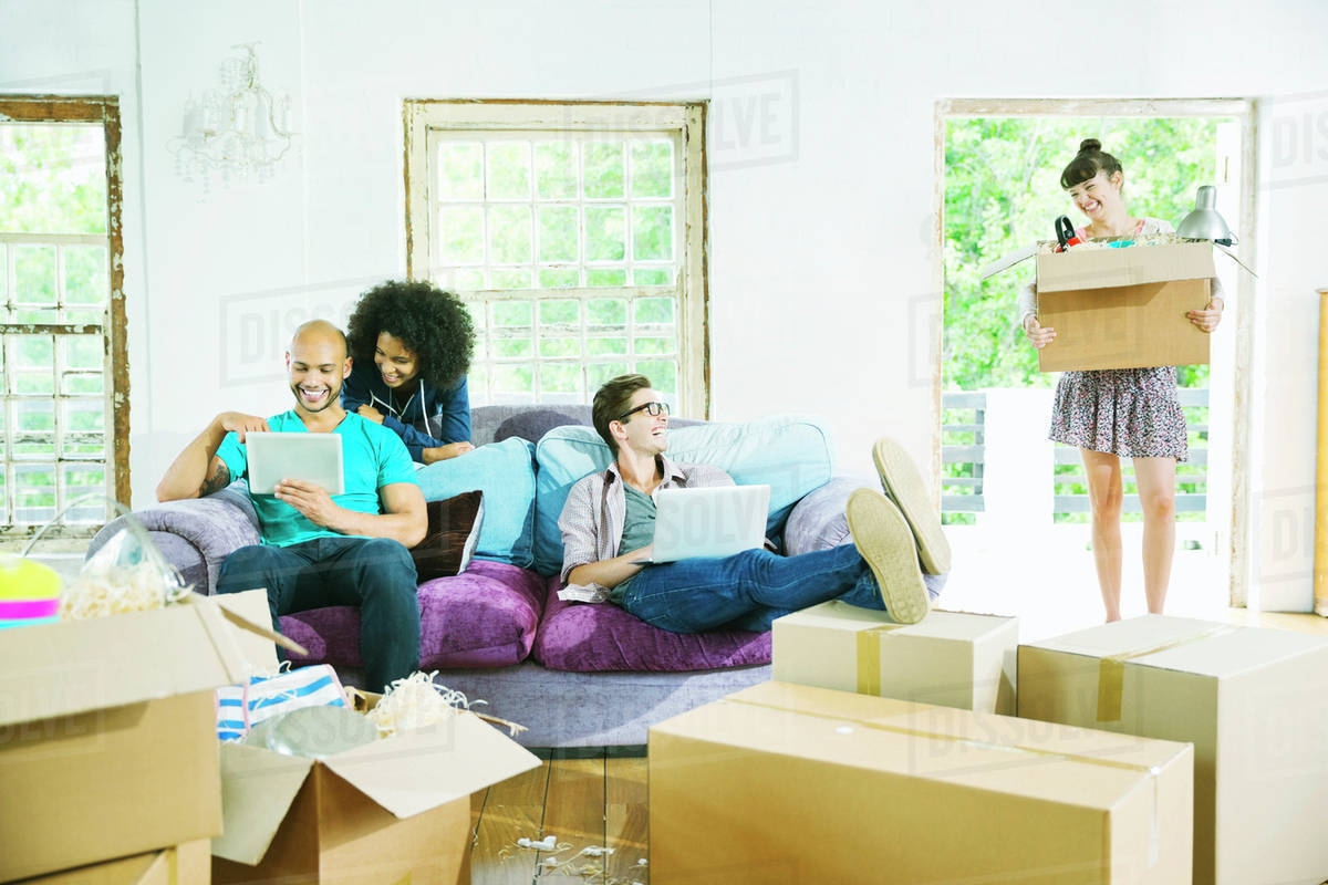 Friends relaxing in new home - Royalty-free Stock Photo | Dissolve