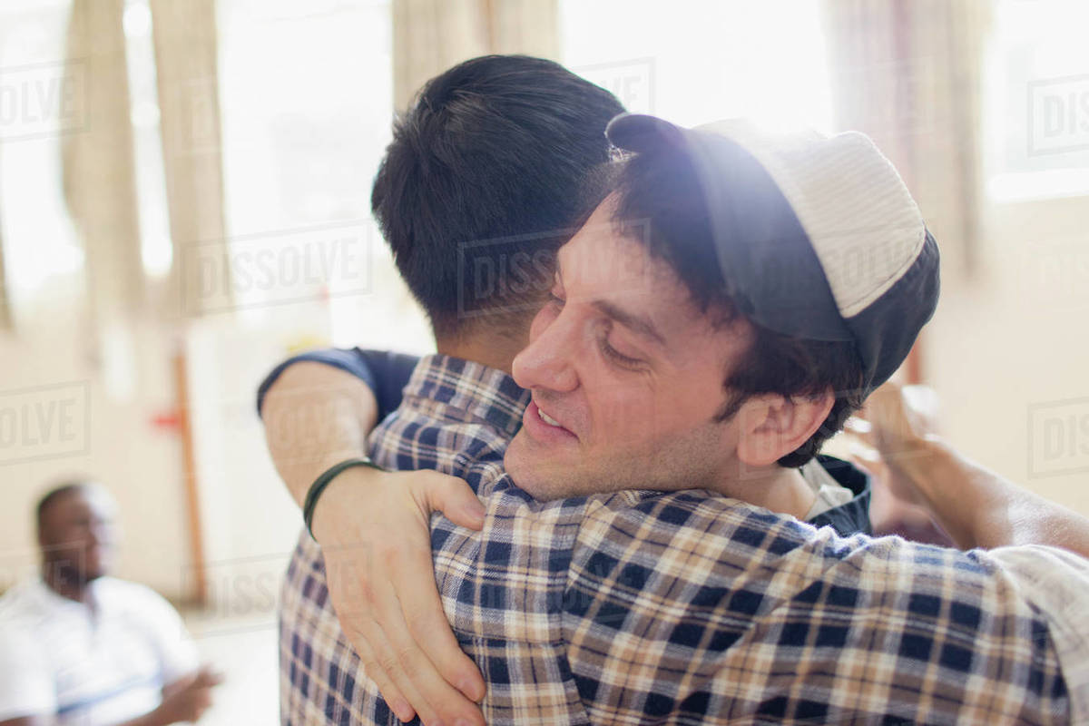 Men hugging - Stock Photo - Dissolve