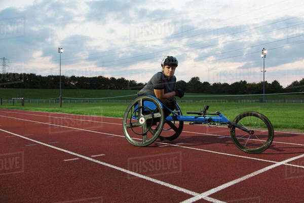 Portrait confident female paraplegic athlete training for wheelchair ...
