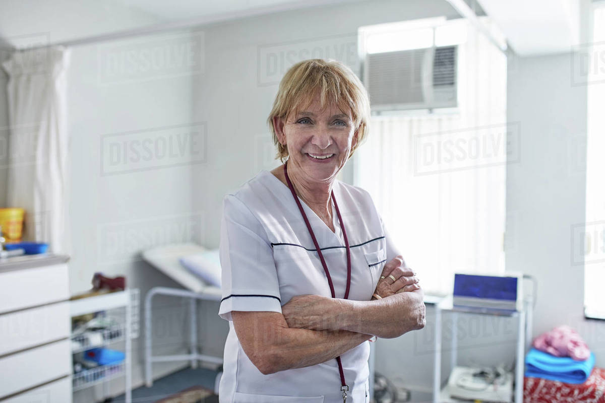Portrait confident senior female nurse in clinic - Royalty-free Stock ...
