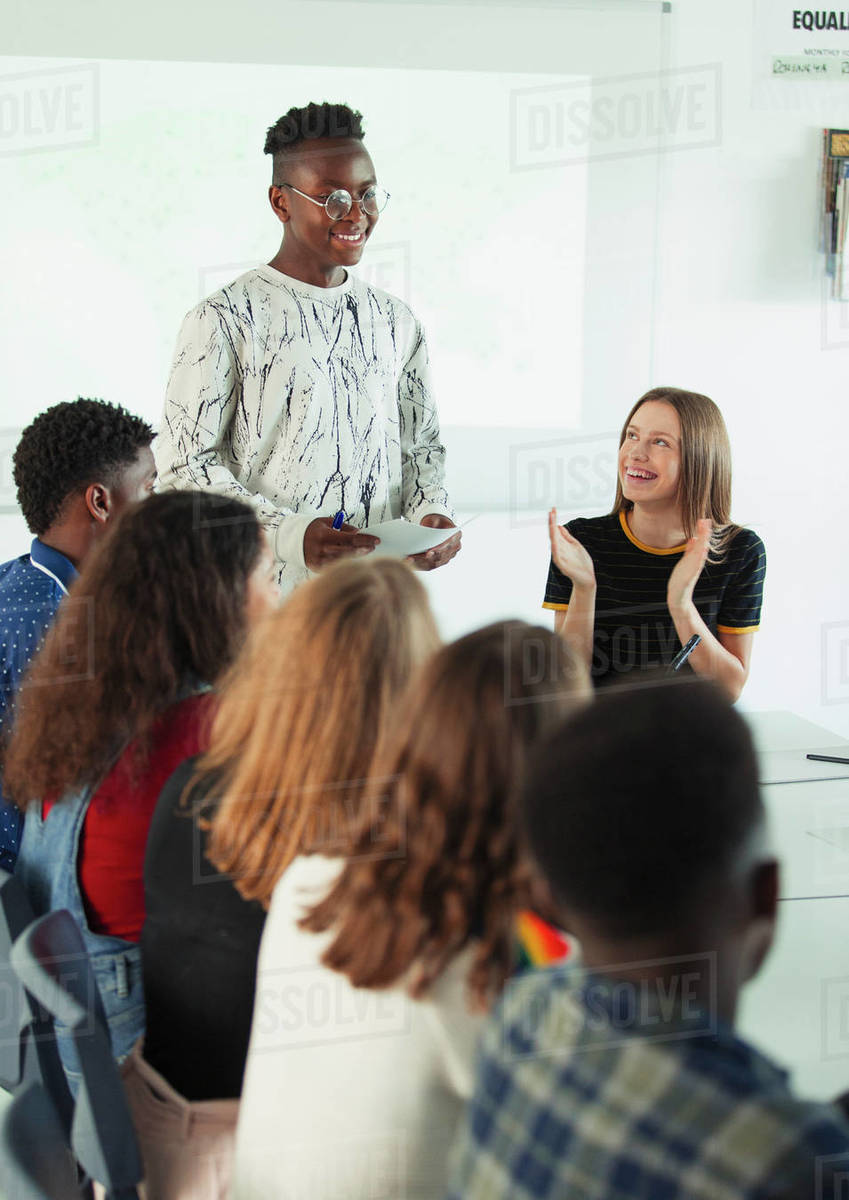 Confident high school boy student giving presentation in classroom ...