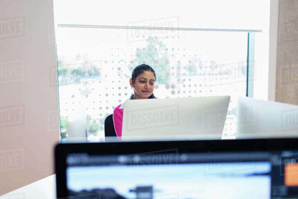 Dedicated female community college student using computer in computer ...