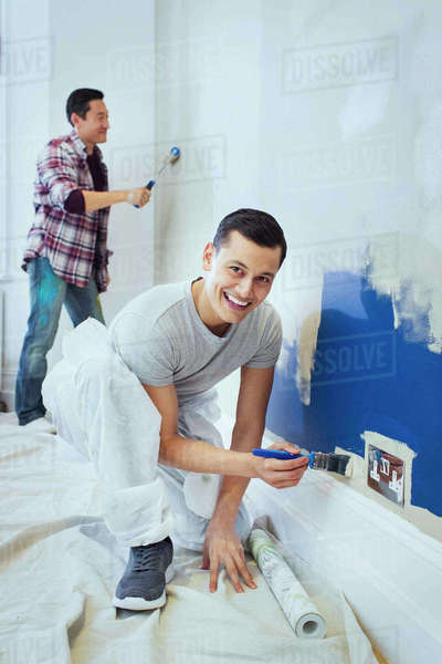 Portrait happy man painting wall - Royalty-free Stock Photo | Dissolve