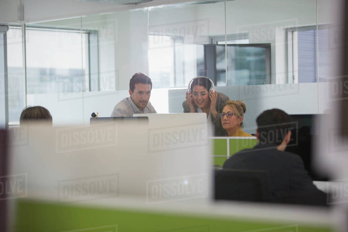 Business people meeting at computer in open plan office - Stock Photo ...