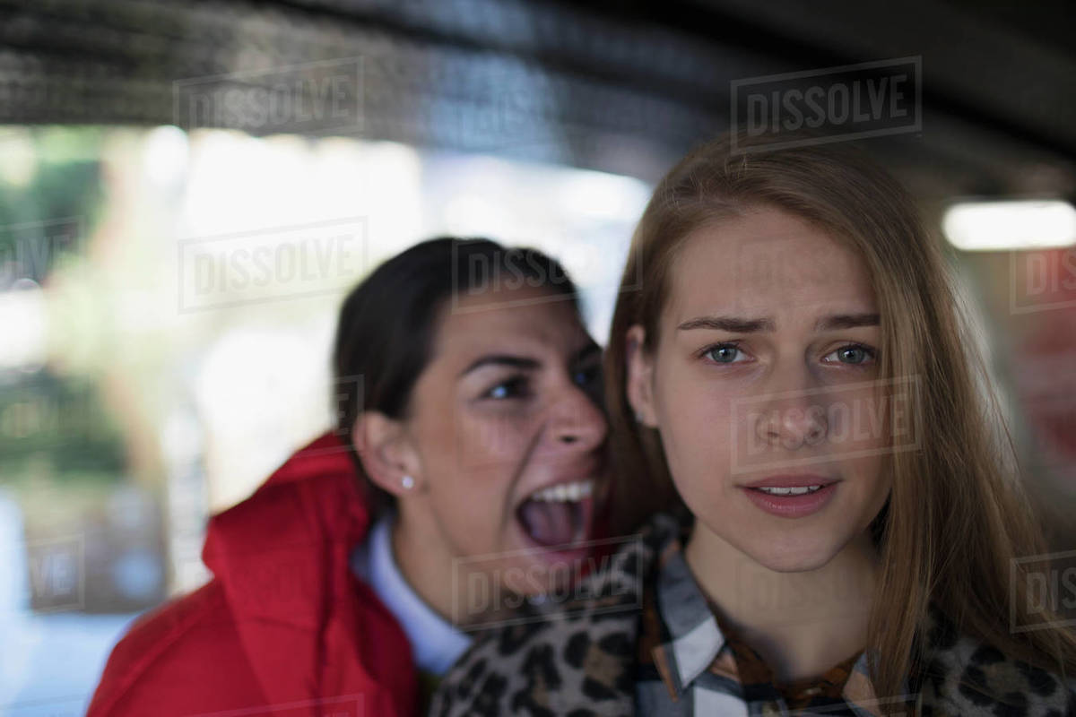 Angry young woman yelling at friend - Royalty-free Stock Photo | Dissolve