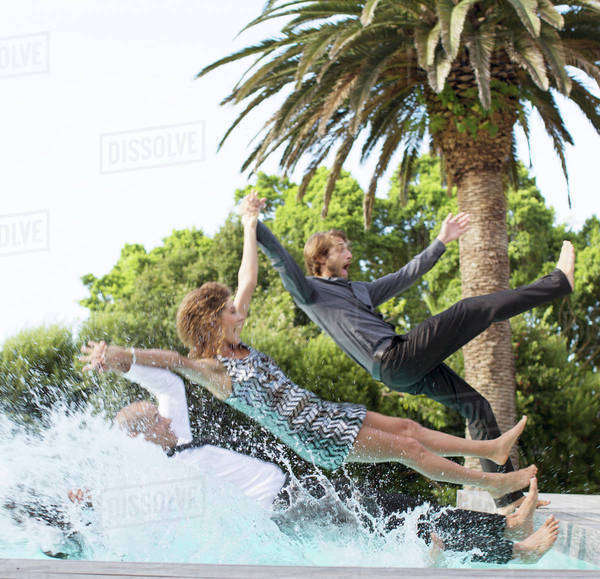 Friends jumping backwards into swimming pool - Royalty-free Stock Photo ...