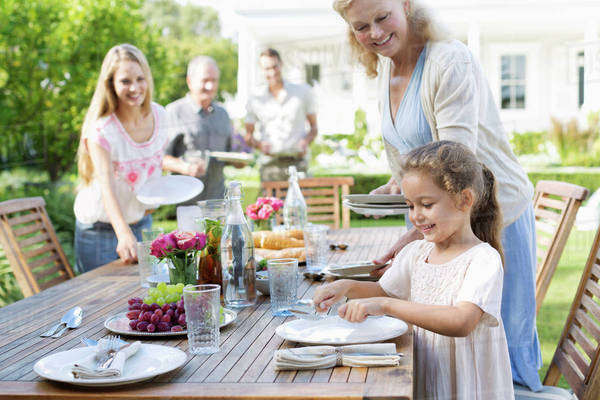 Family setting table outdoors - Royalty-free Stock Photo | Dissolve