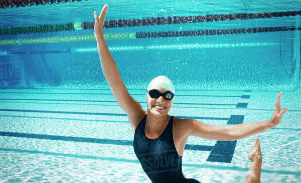 Swimmer posing underwater in pool - Royalty-free Stock Photo | Dissolve