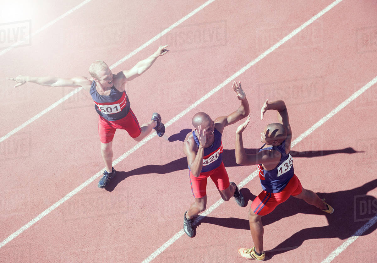Runners cheering on track - Royalty-free Stock Photo | Dissolve