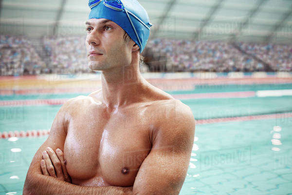 Serious swimmer standing poolside - Royalty-free Stock Photo | Dissolve