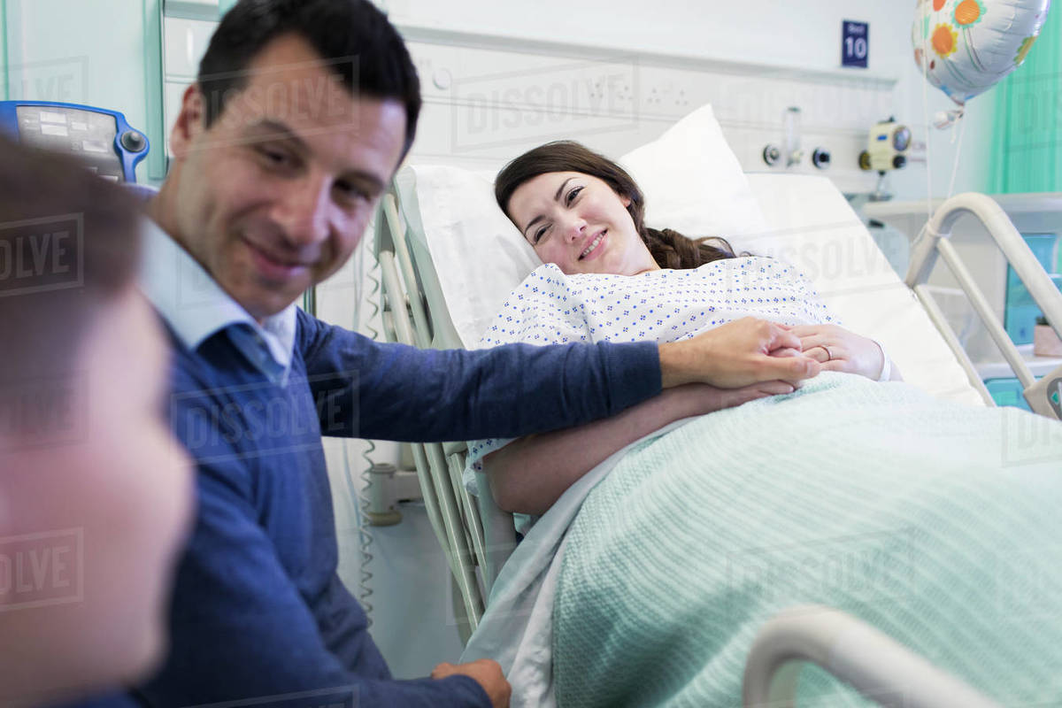 Affectionate family visiting patient in hospital room - Royalty-free ...