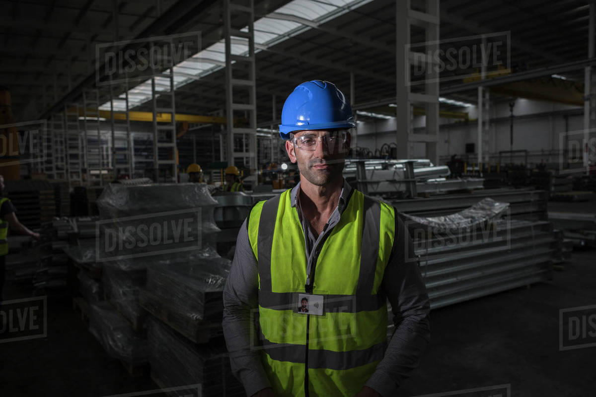 Portrait confident, serious worker in dark steel factory - Stock Photo ...