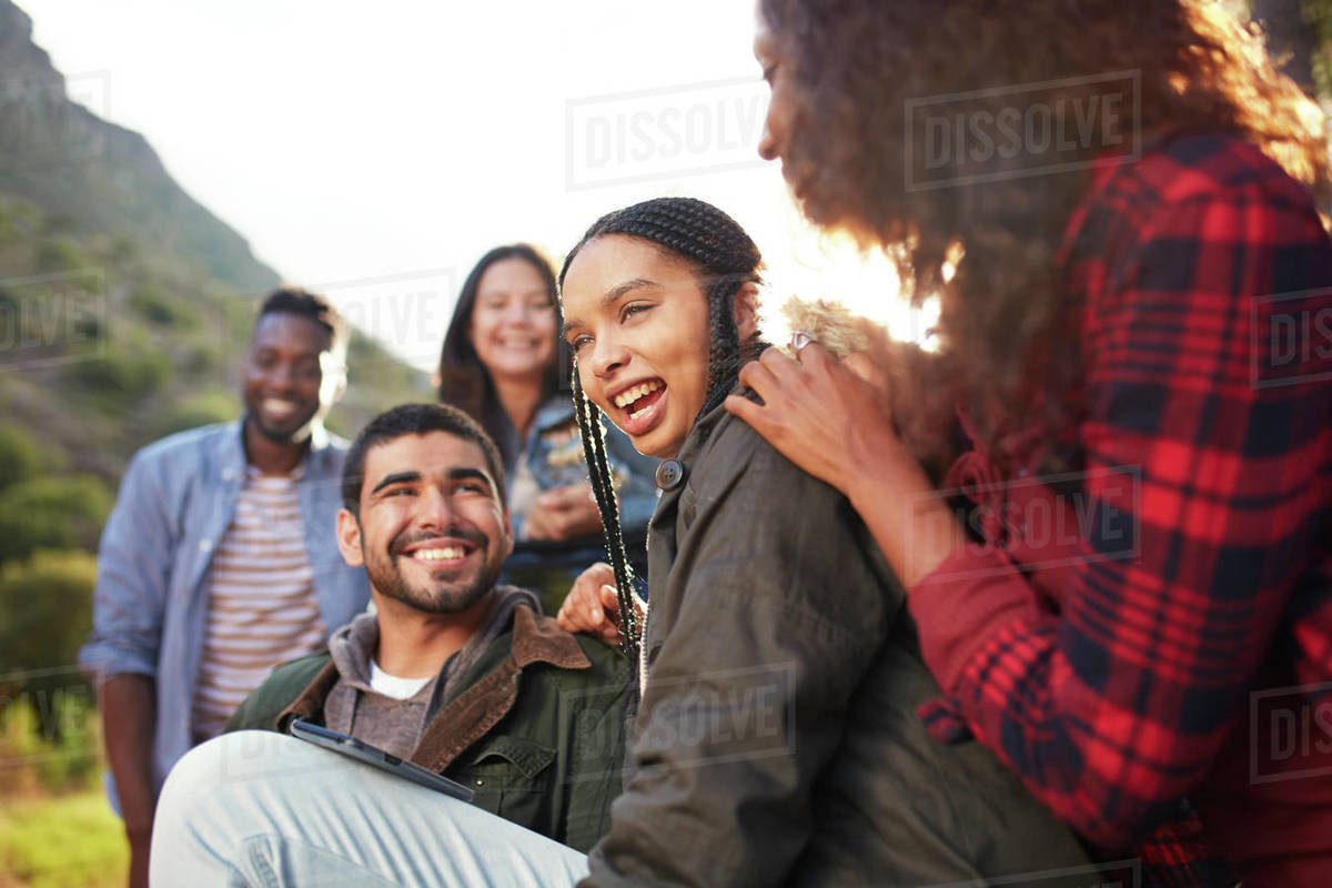 Young friends laughing, hanging out - Stock Photo - Dissolve