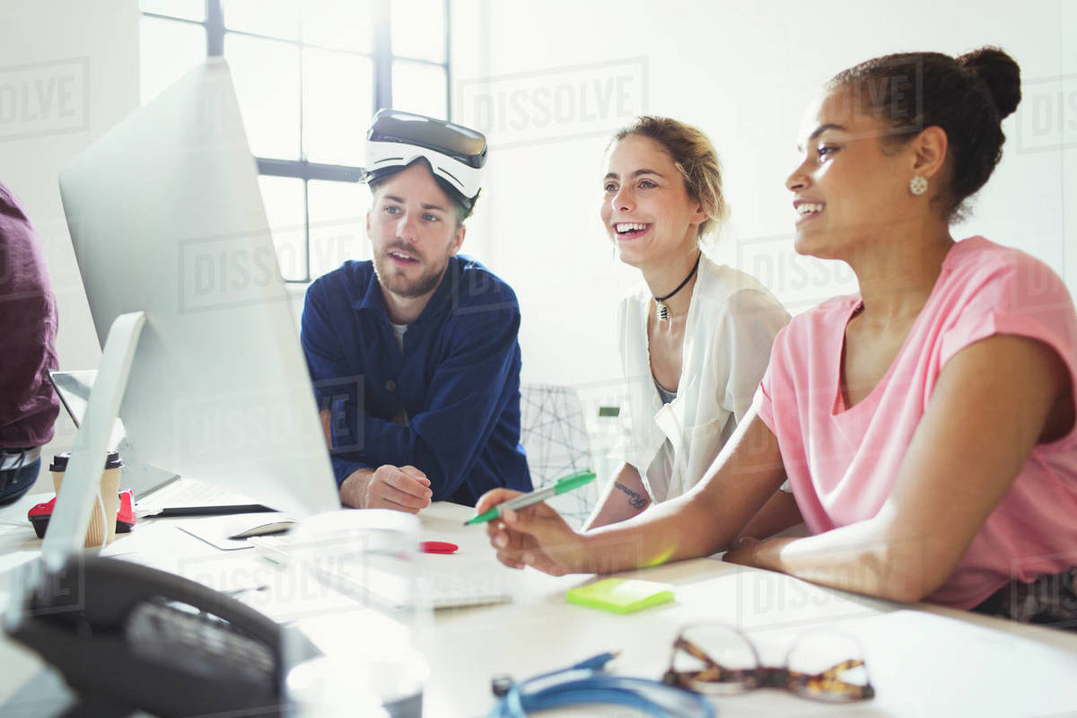 Computer programmers programming virtual reality simulator glasses at computer in office - Stock ...