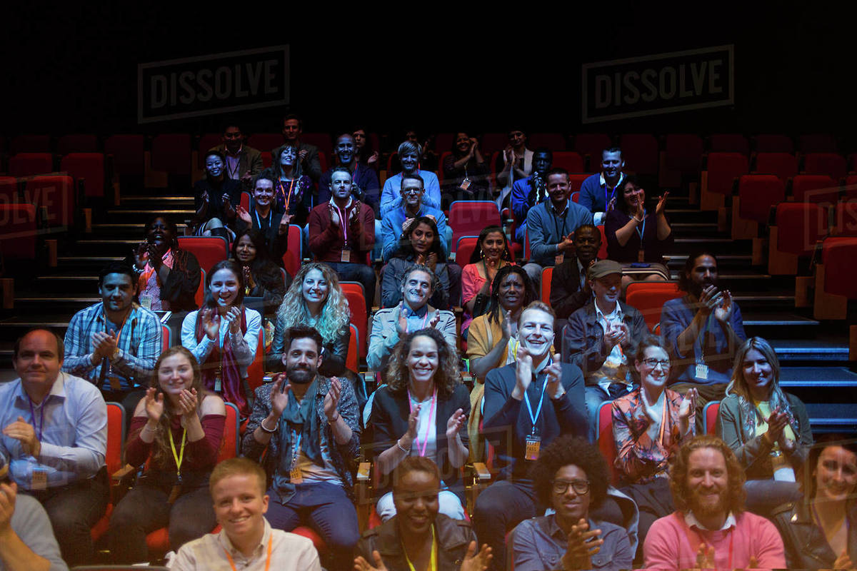 Smiling audience clapping - Stock Photo - Dissolve