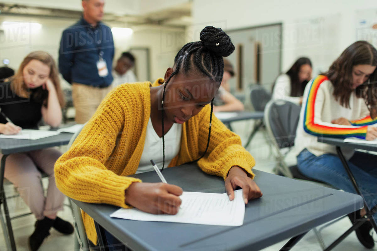 Focused high school girl student taking exam at desk - Stock Photo ...