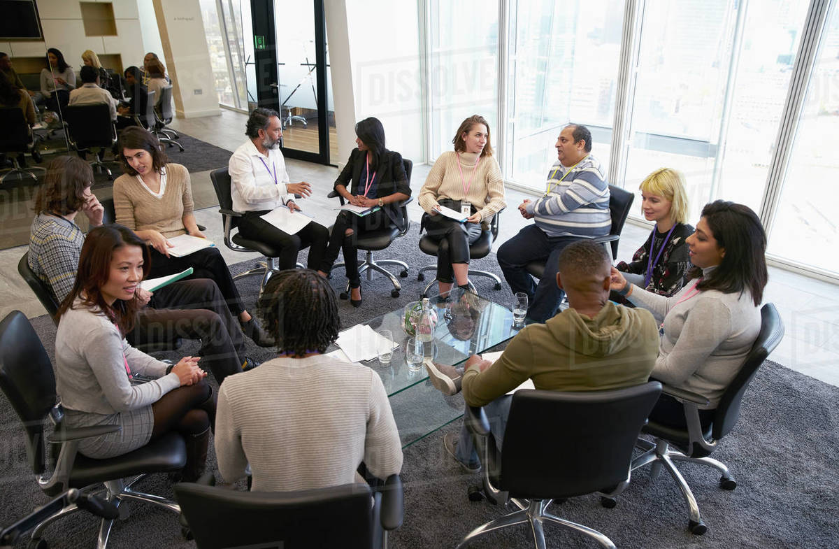 Business people talking in circle in conference room meeting - Stock ...