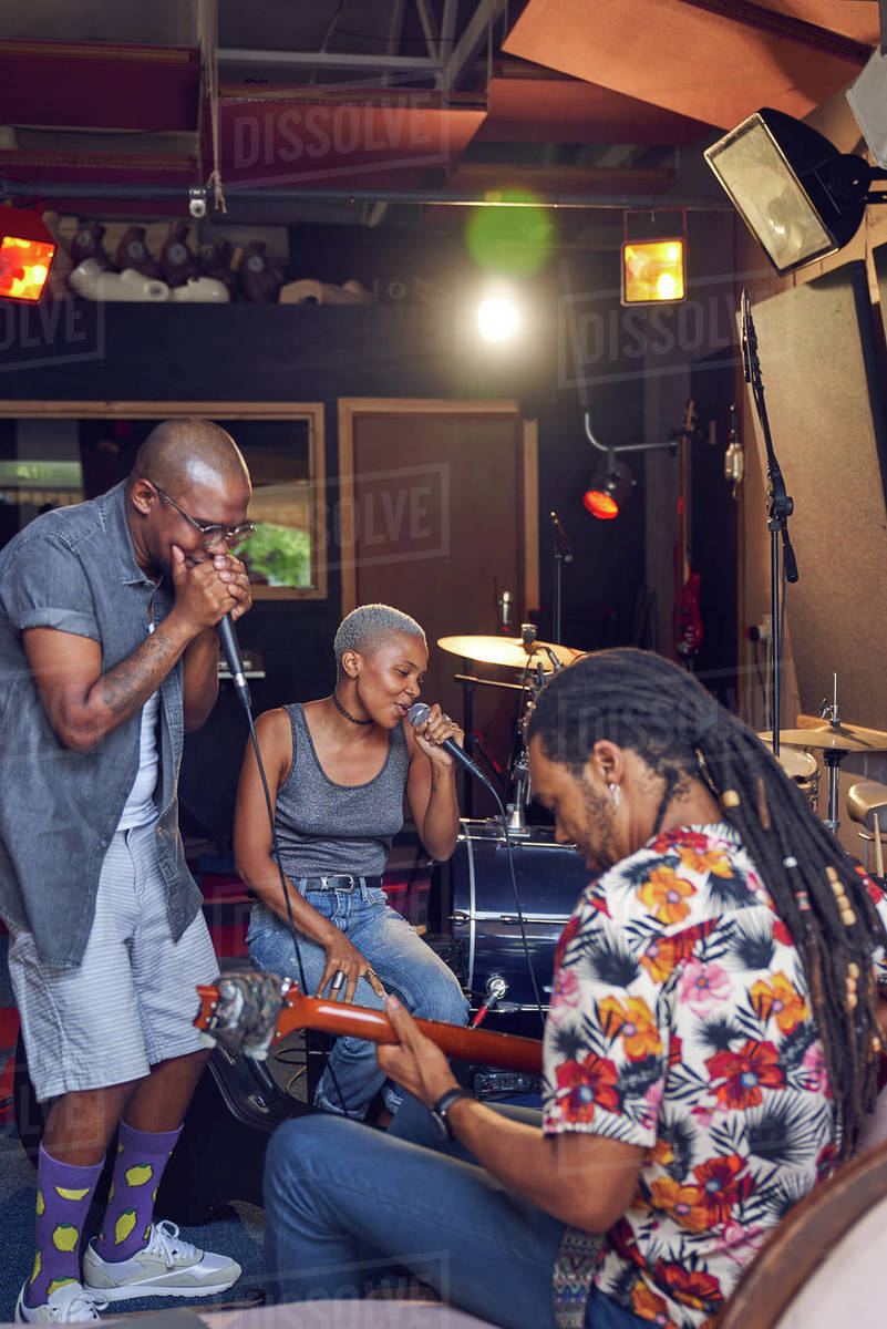 Musicians practicing in recording studio - Stock Photo - Dissolve