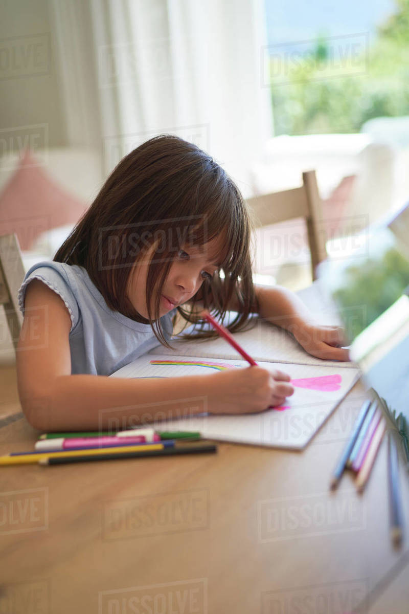 Girl drawing at table - Stock Photo - Dissolve