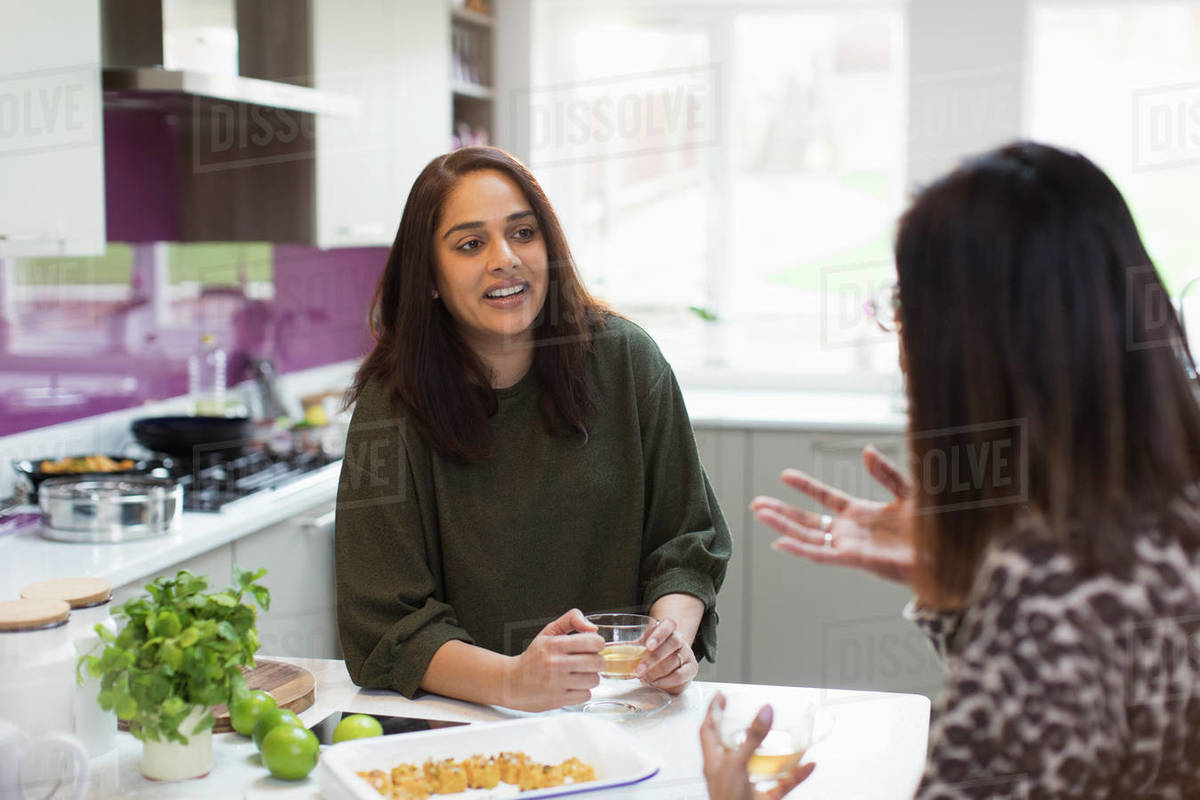 Women talking and drinking tea in kitchen - Royalty-free Stock Photo ...