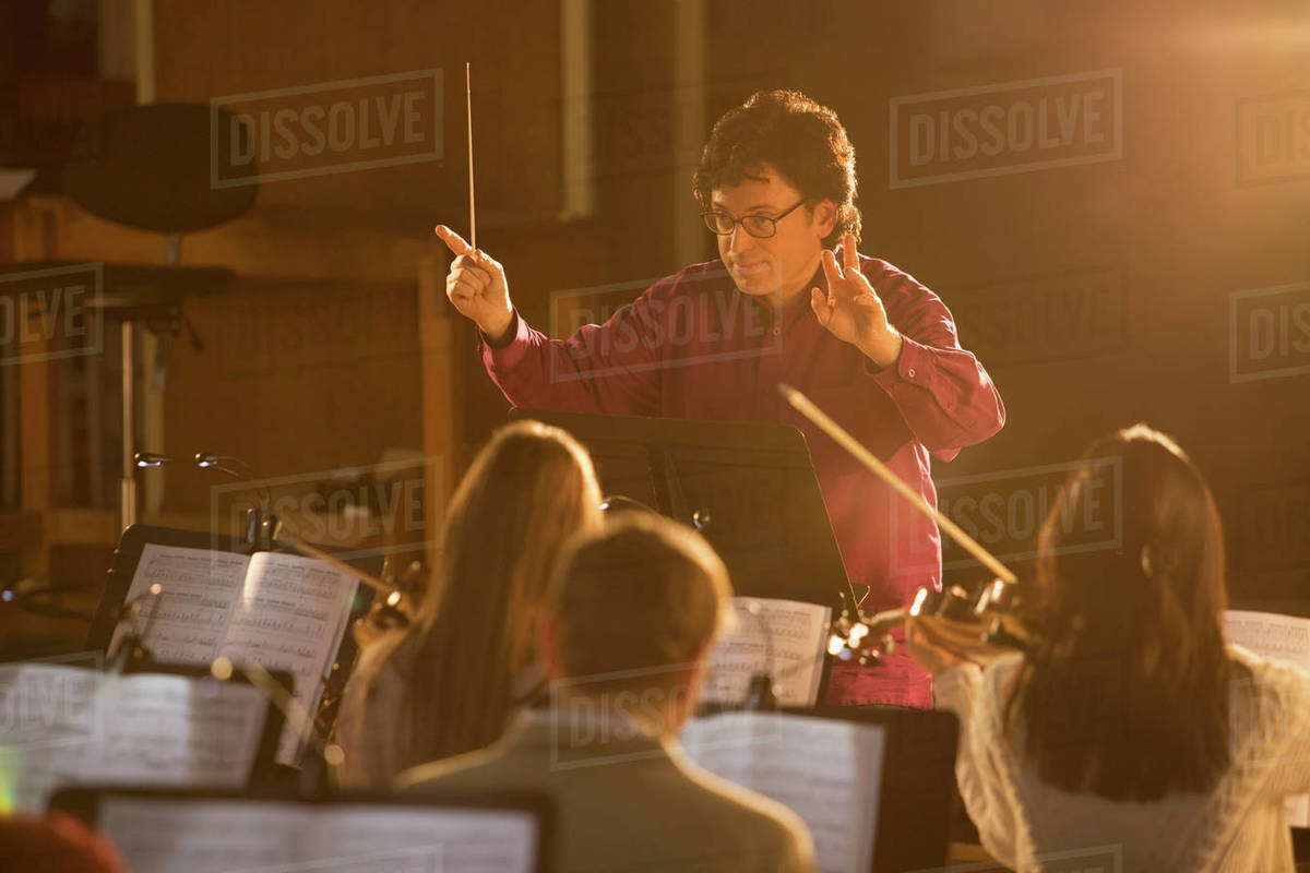 Conductor leading orchestra - Royalty-free Stock Photo | Dissolve