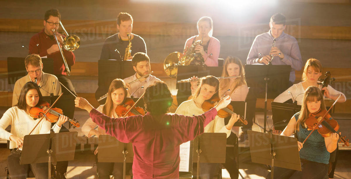 Conductor leading orchestra - Stock Photo - Dissolve