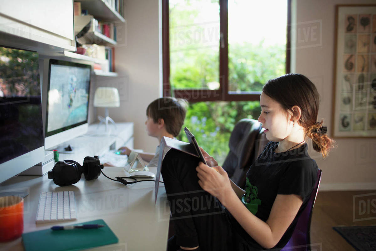 Brother and sister e-learning at digital tablet and computer - Royalty ...