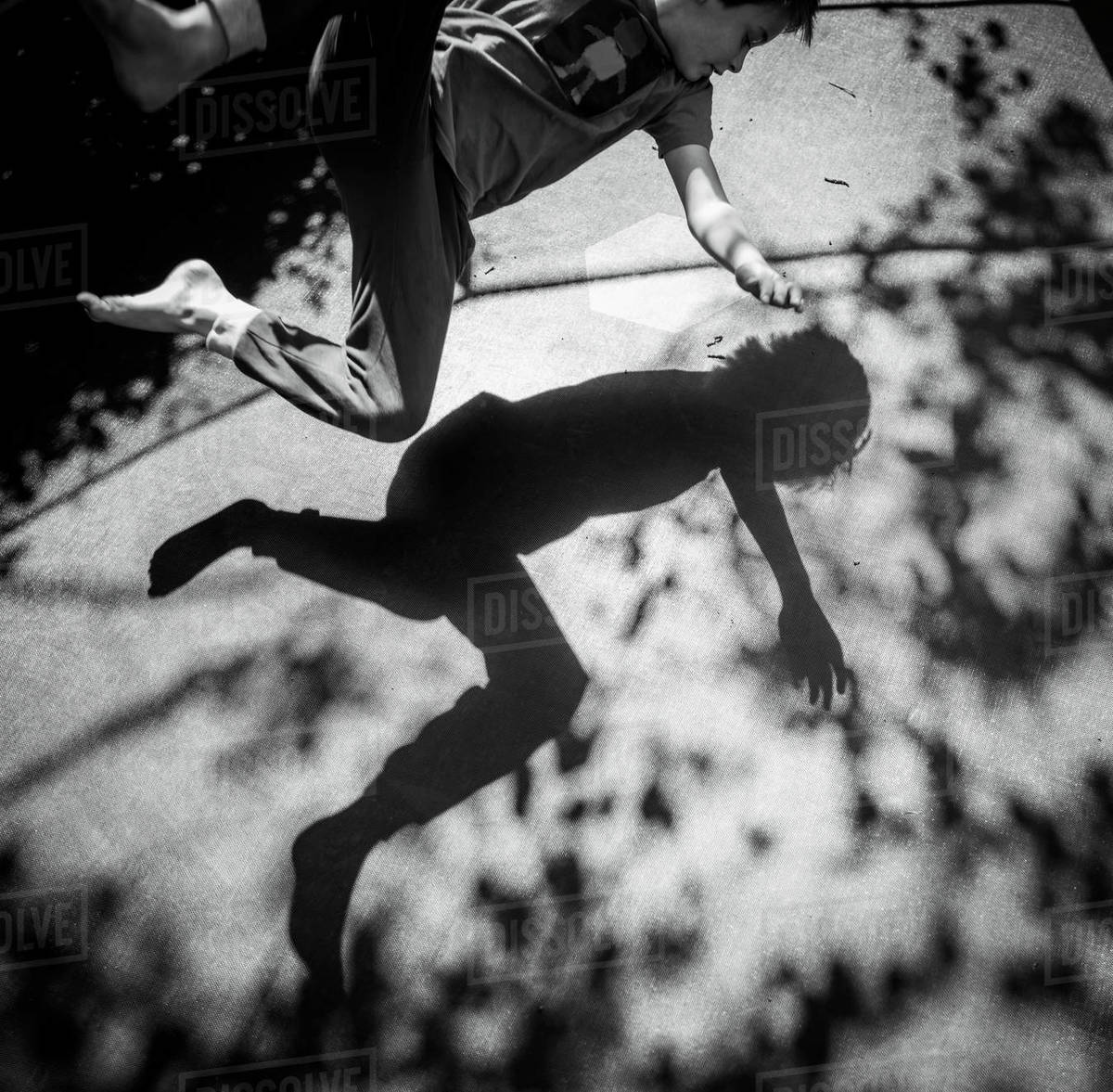 Shadow of boy jumping on sunny trampoline - Royalty-free Stock Photo ...