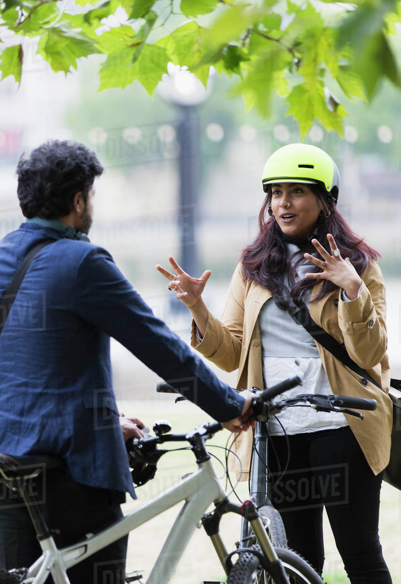 Business people with bicycle talking in park - Royalty-free Stock Photo ...