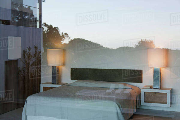 View of modern bedroom through window - Stock Photo - Dissolve