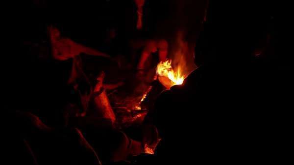 People sitting around a fire talking at night - Stock Video Footage ...