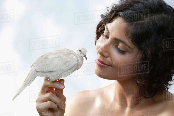 Woman holding dove on finger - Royalty-free Stock Photo | Dissolve