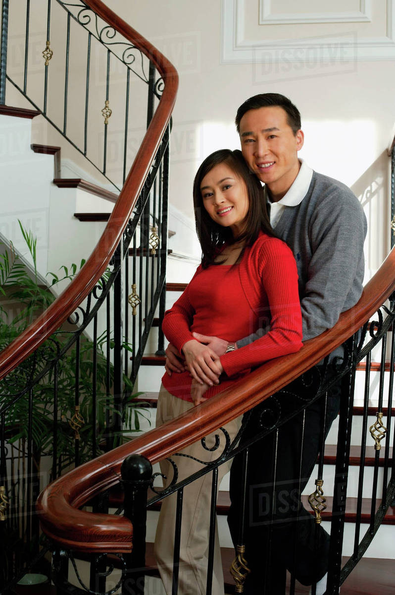 Young couple on stairs smiling at camera - Royalty-free Stock Photo ...