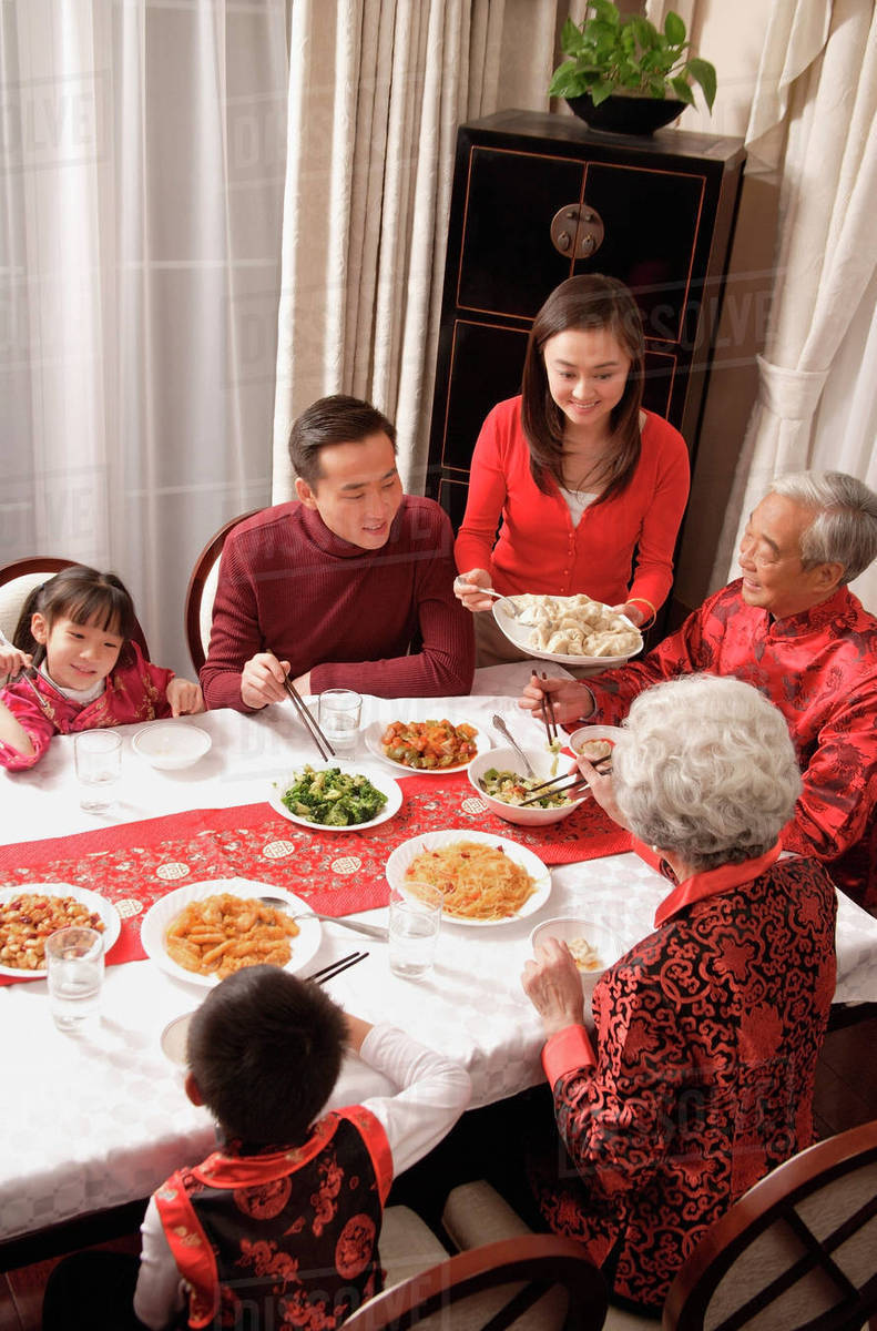 Family at dinner table having traditional food - Royalty-free Stock ...