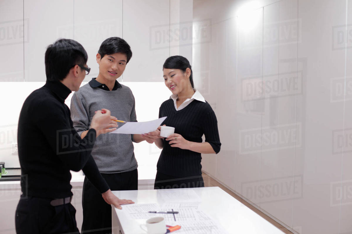 Three people working together in modern office - Stock Photo - Dissolve