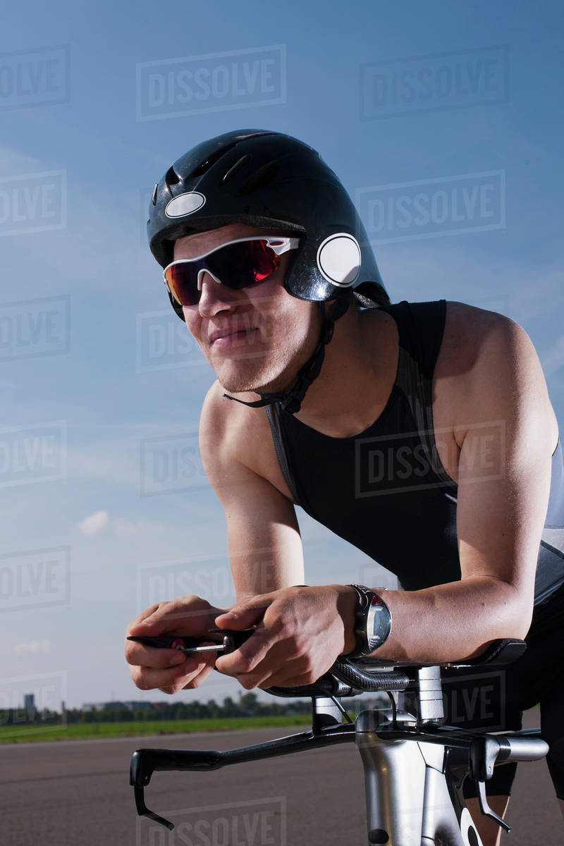 A cyclist on a racing bicycle, close-up - Stock Photo - Dissolve