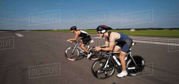 Two cyclists on racing bicycles, side view, low angle view - Stock ...