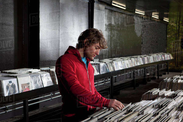 A young man looking through records at a record store - Stock Photo ...