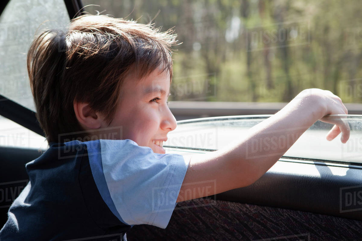A child looking out a car window - Royalty-free Stock Photo | Dissolve