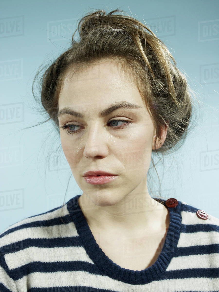 A woman with tears running down her face - Stock Photo - Dissolve